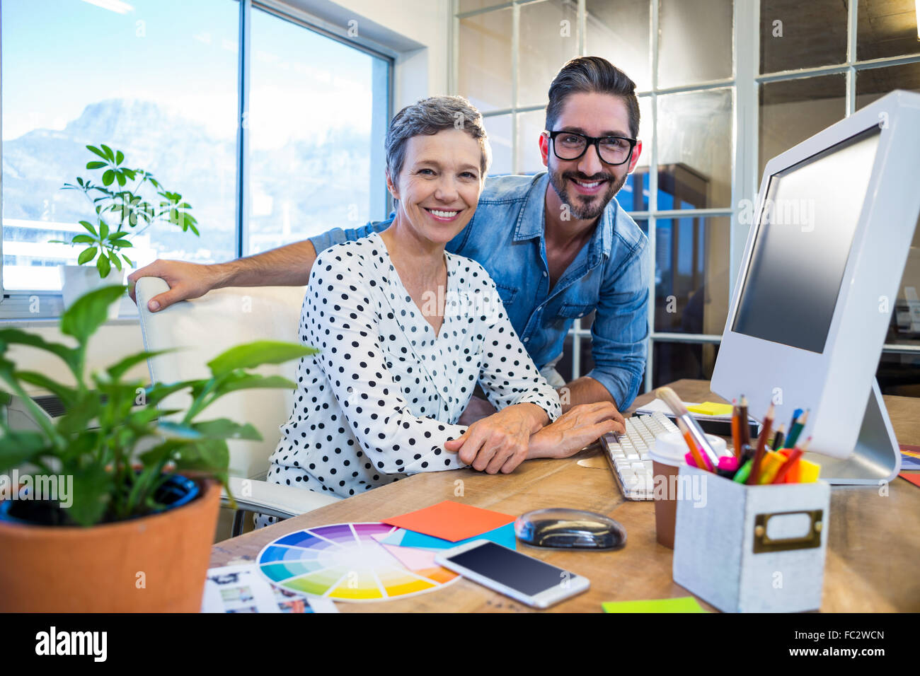 Casual designers smiling at camera Stock Photo - Alamy Casual designers smiling at camera Stock Photo - Alamy