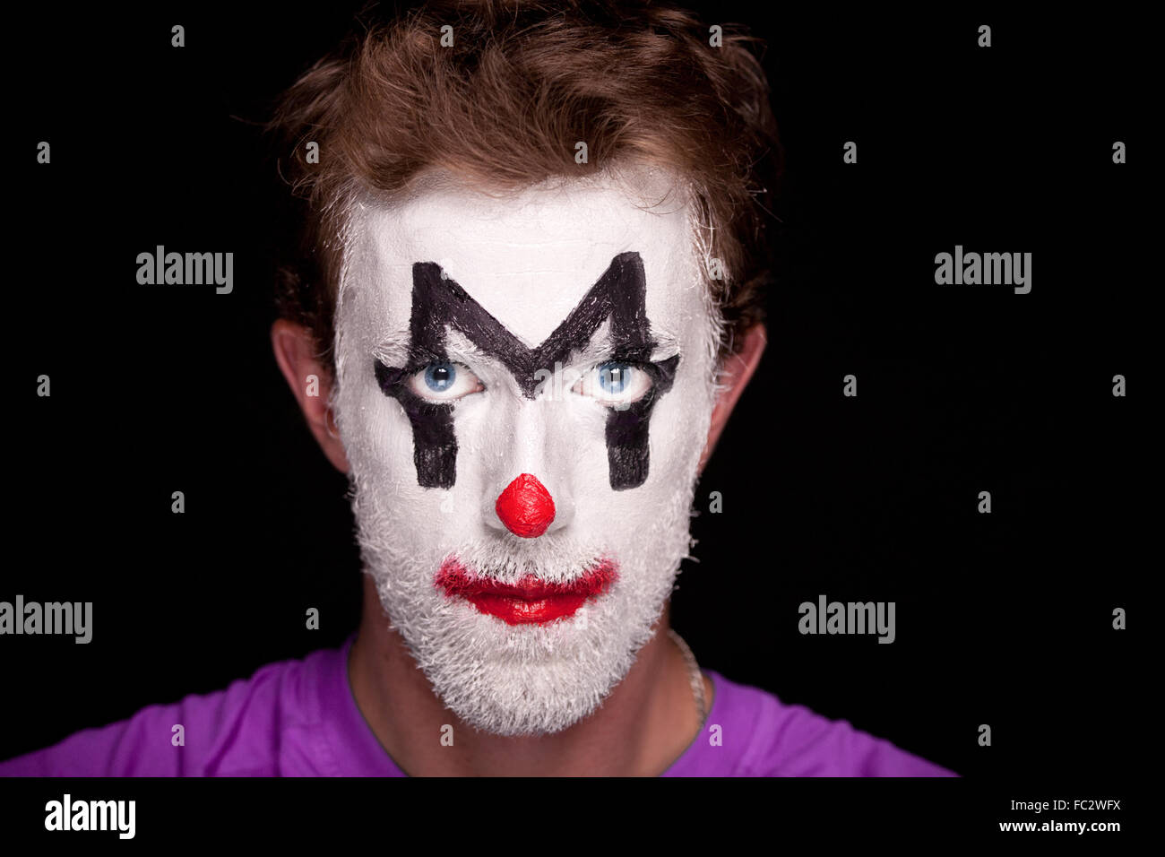 A man with clown makeup on his face Stock Photo - Alamy