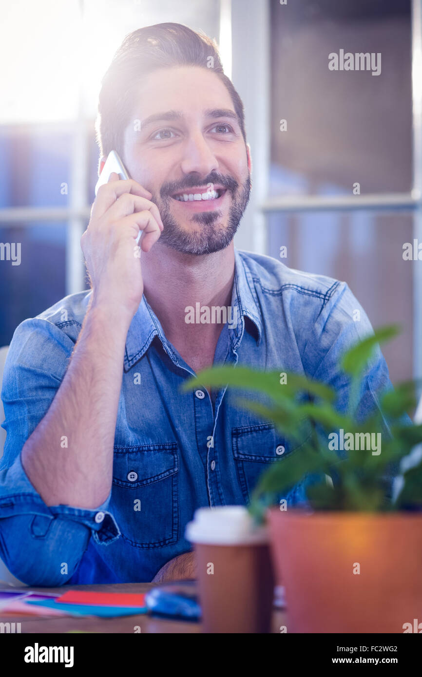 Happy editor on the phone Stock Photo - Alamy