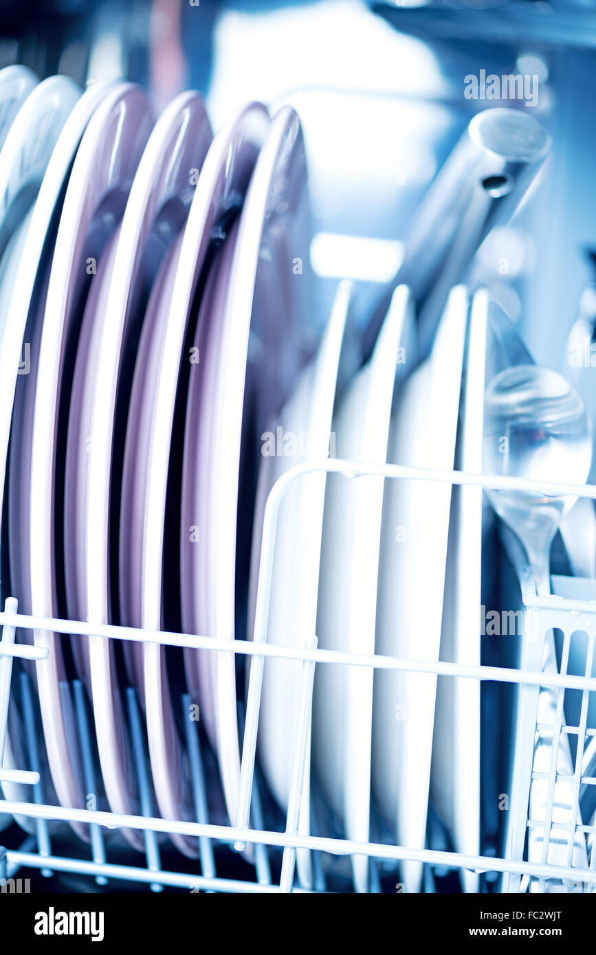 Clean kitchenware in dishwasher macro Stock Photo - Alamy