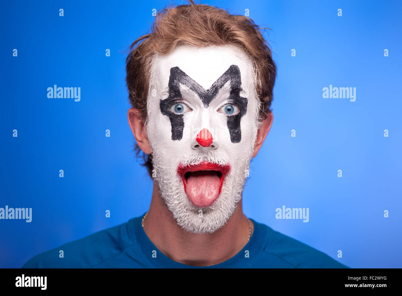 A man with clown makeup on his face Stock Photo - Alamy