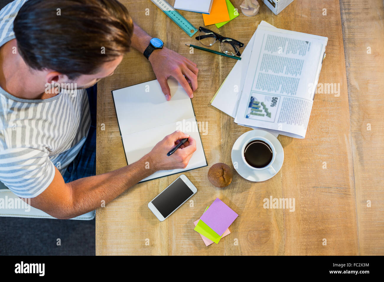 Casual businessman writing in notepad Stock Photo - Alamy