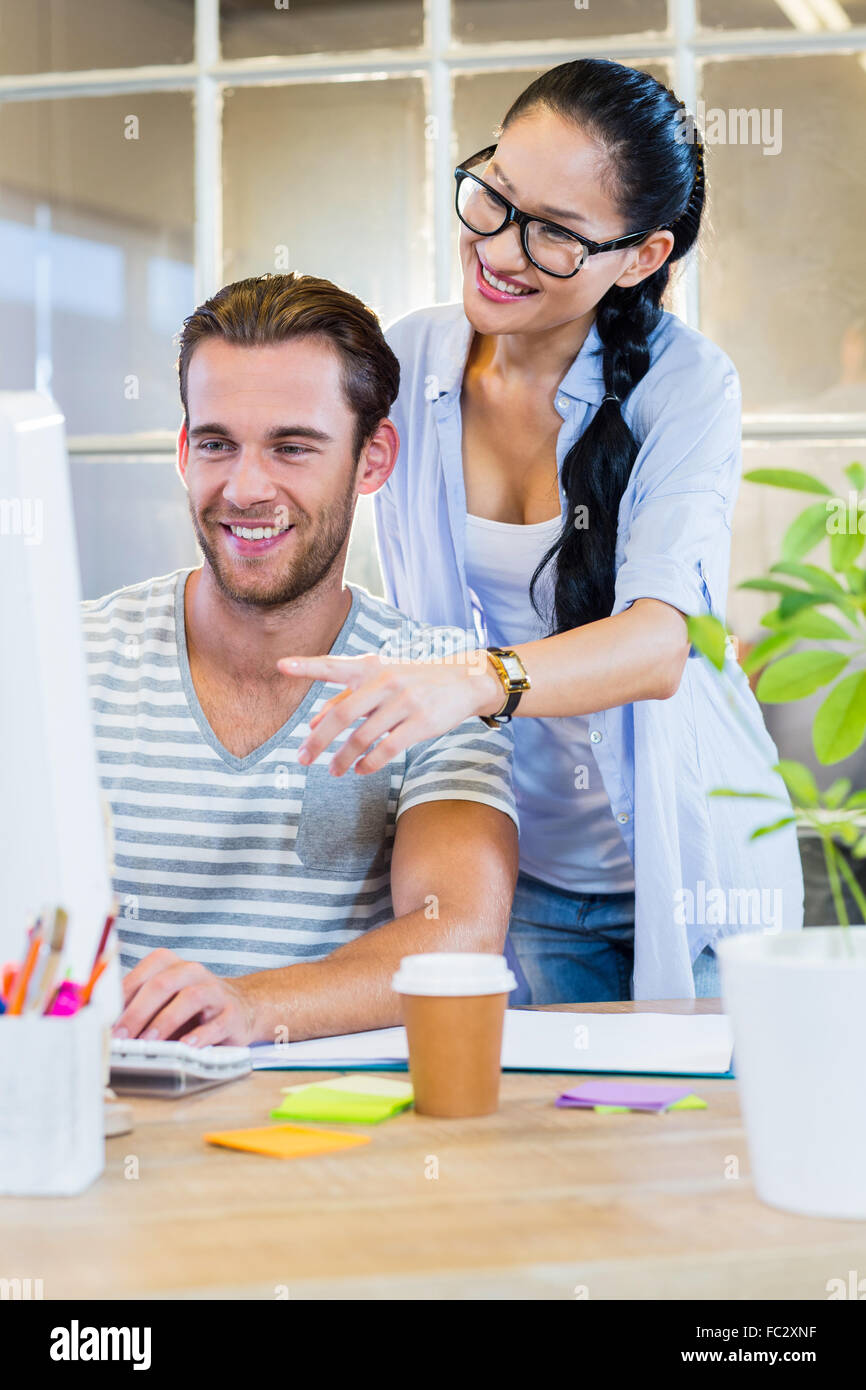 Smiling partners working together on computer Stock Photo - Alamy