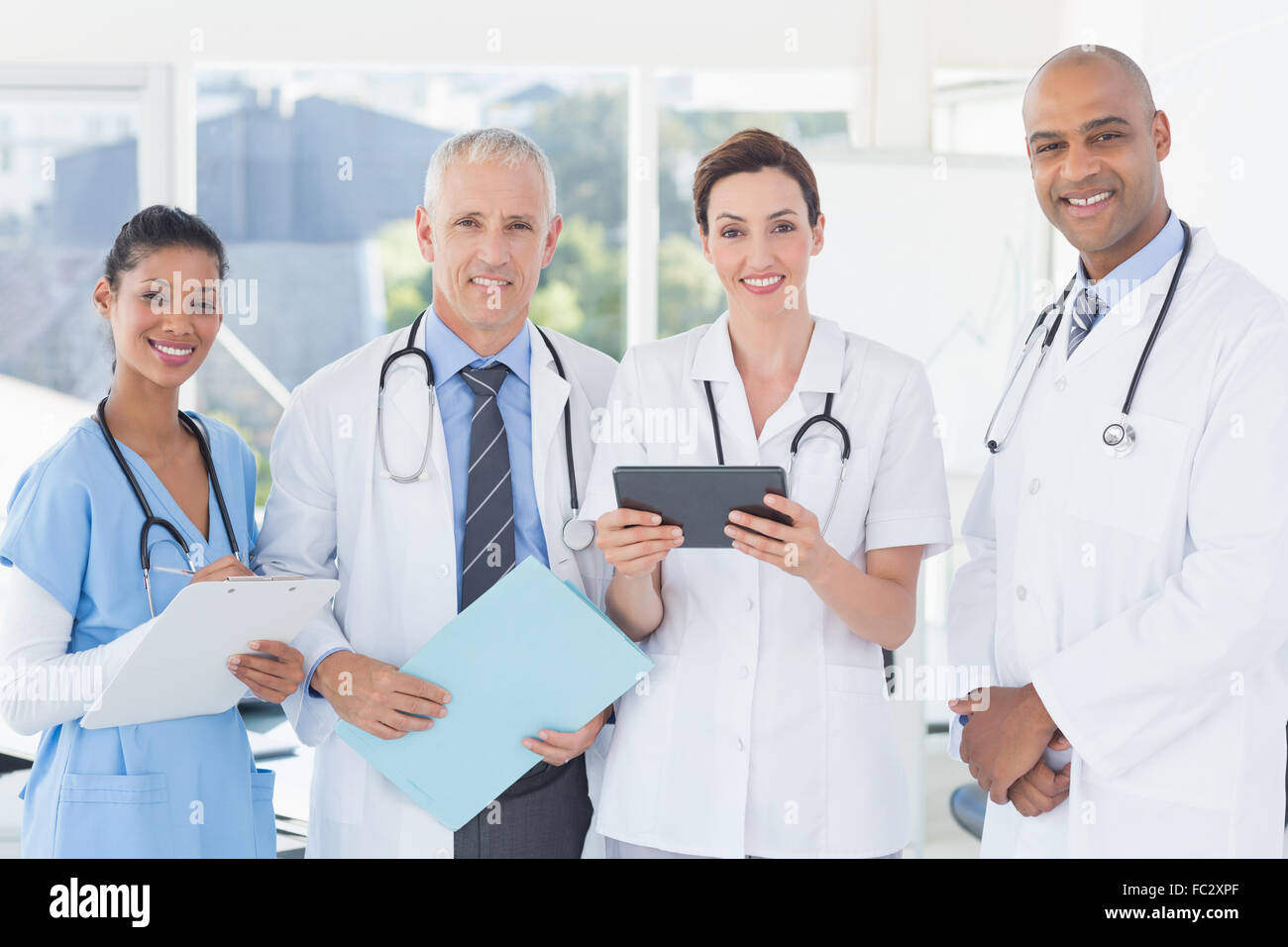 Team of doctors working together on patients file Stock Photo - Alamy
