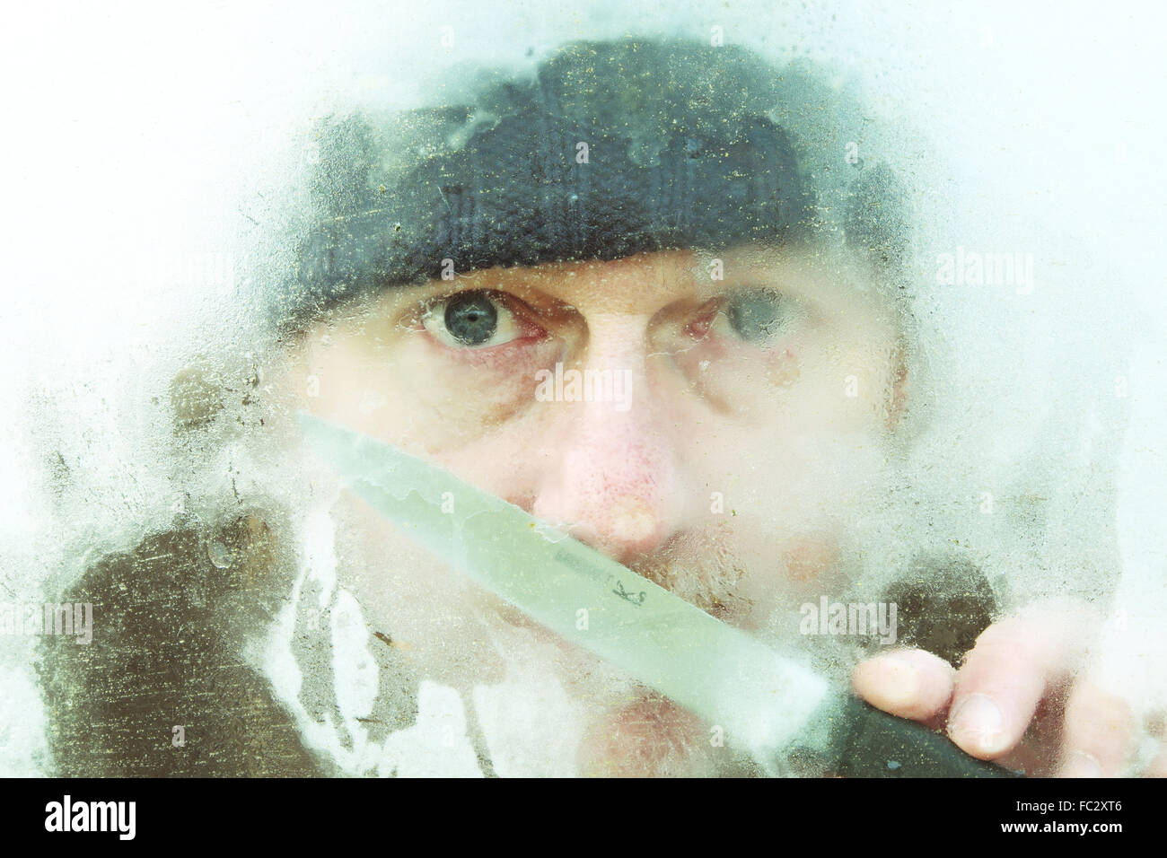 Scary man with knife outside a frozen window in winter Stock Photo - Alamy