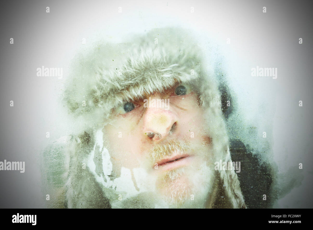 Man with fur hat and face pressed up against an icy frozen window Stock ...