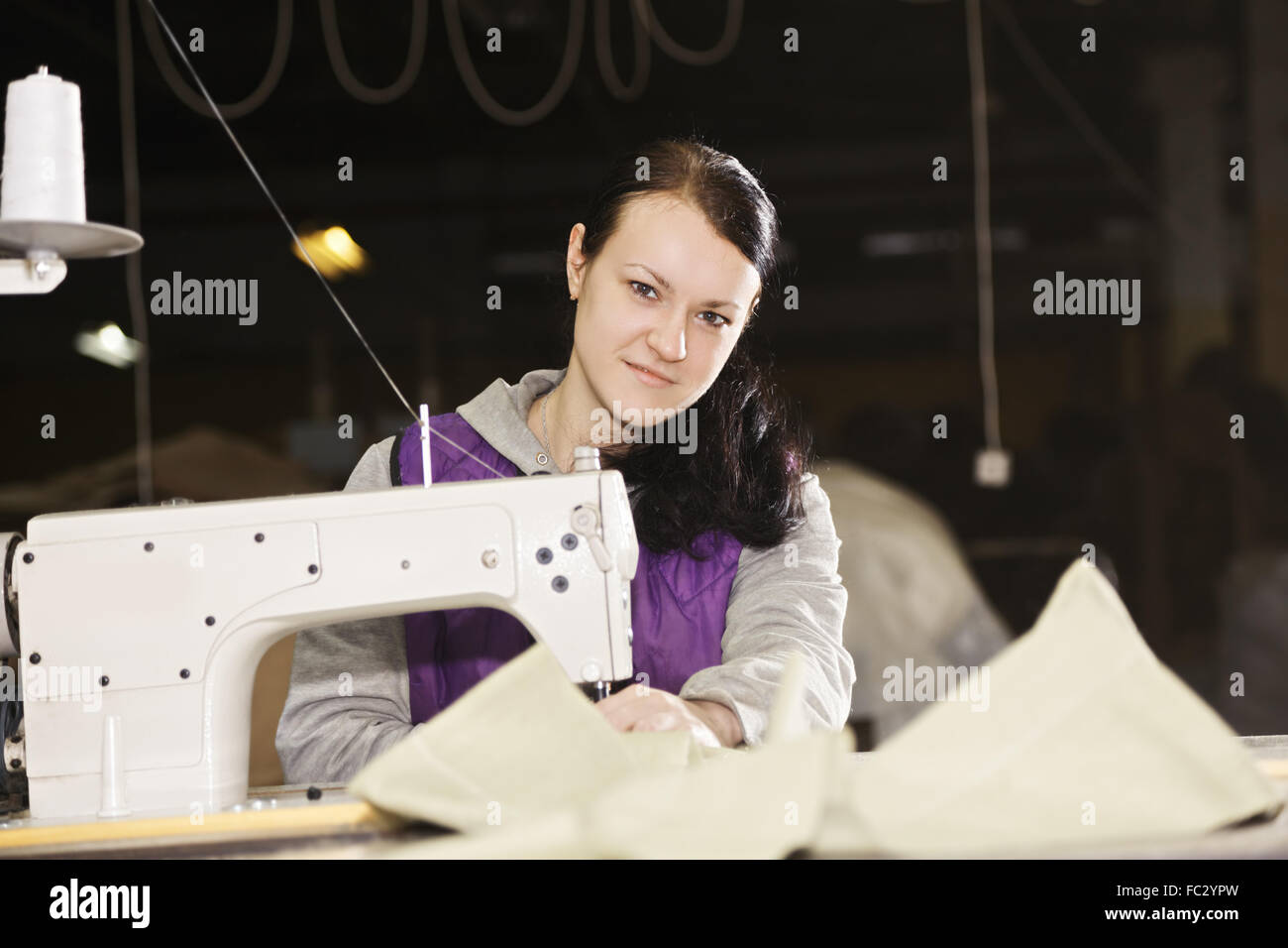 Young seamstress sewing Stock Photo - Alamy