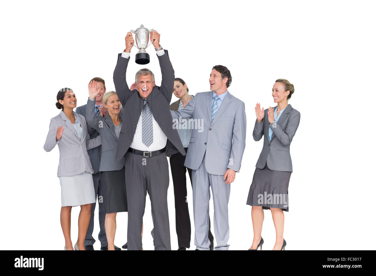 Excited business team cheering at camera with trophy Stock Photo - Alamy