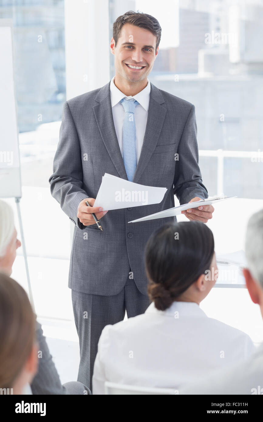 Happy businessman looking at camera during meeting Stock Photo - Alamy