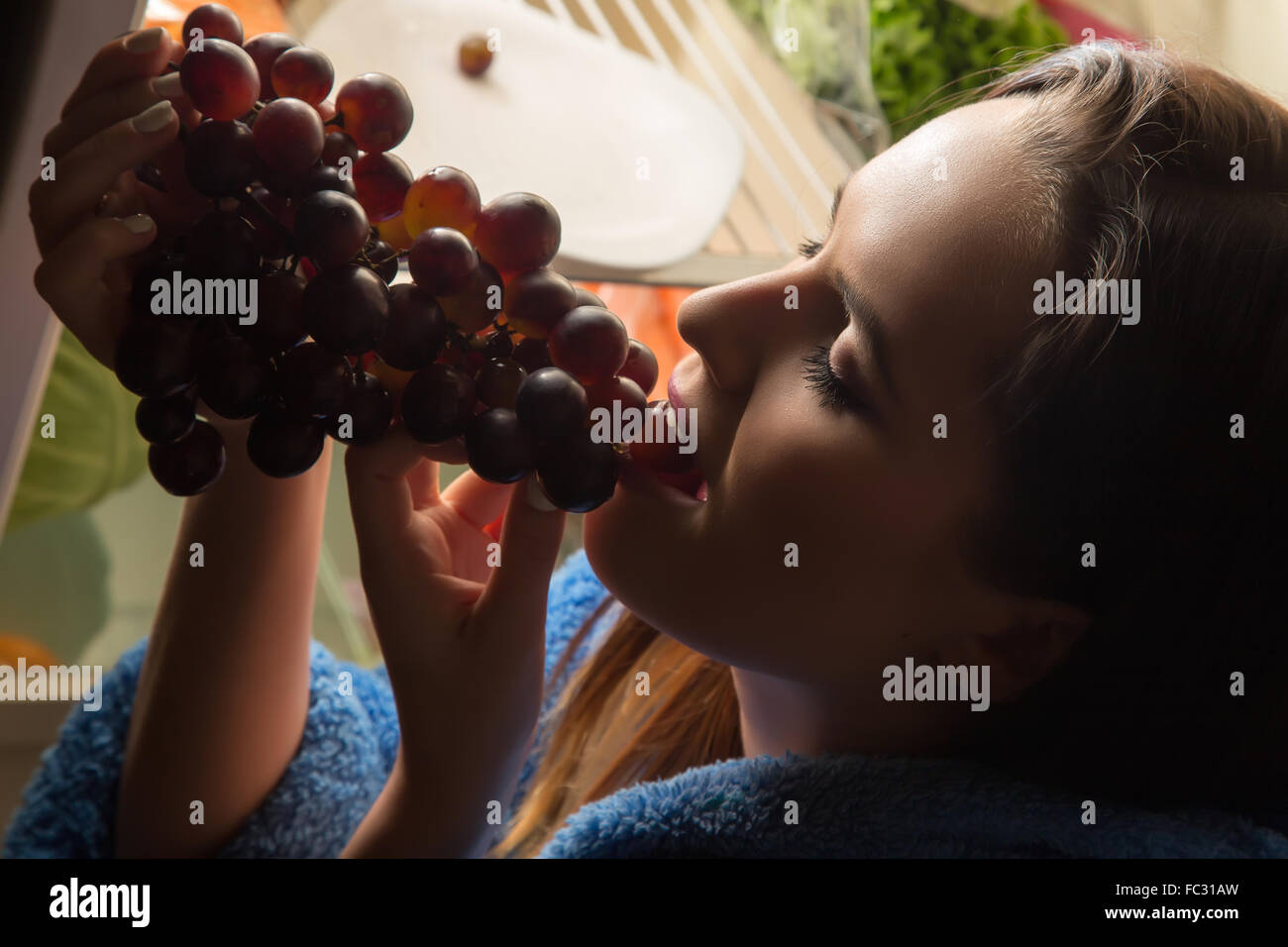 Woman eating grapes hi-res stock photography and images - Alamy