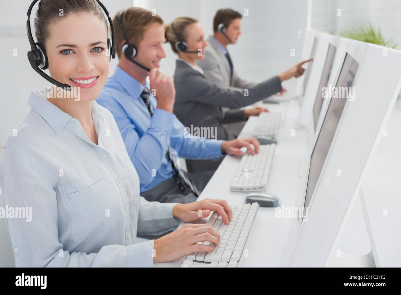 Office team wearing headsets typing hi-res stock photography and images ...