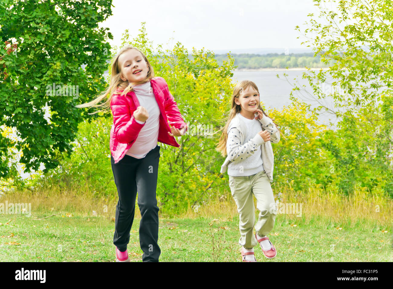 Cute two running girls Stock Photo - Alamy