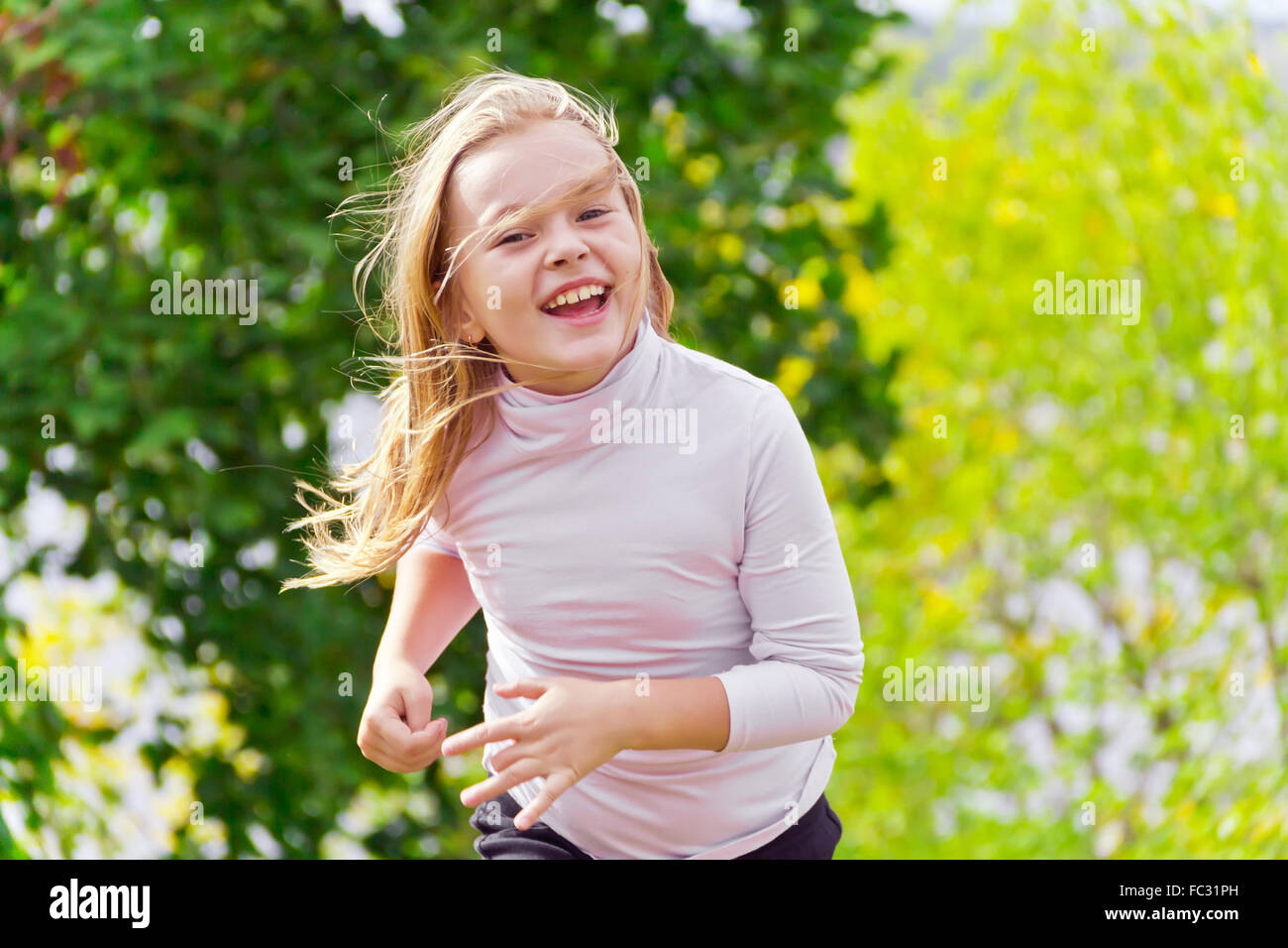 Cute running girl Stock Photo - Alamy