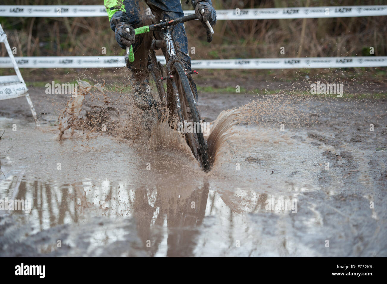 Cyclocross rider riding through water during a race Stock Photo - Alamy