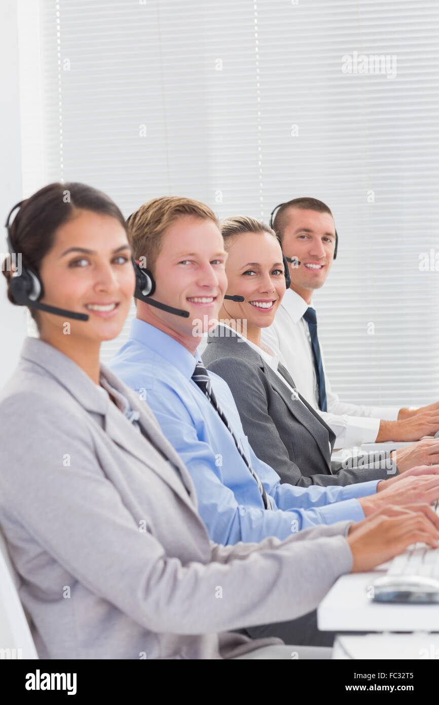 Business team working on computers and wearing headsets Stock Photo - Alamy