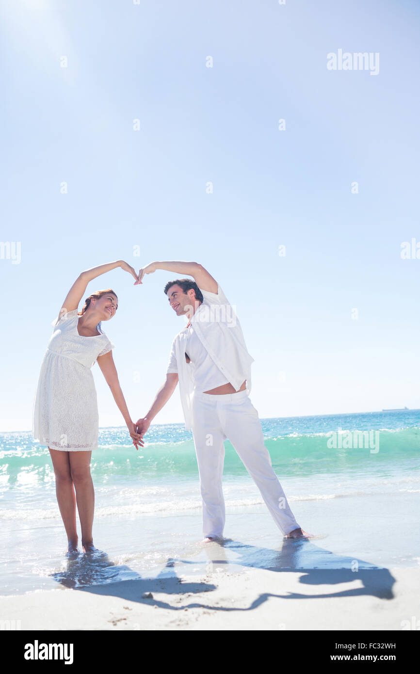 Happy couple forming heart shape with their hands Stock Photo - Alamy