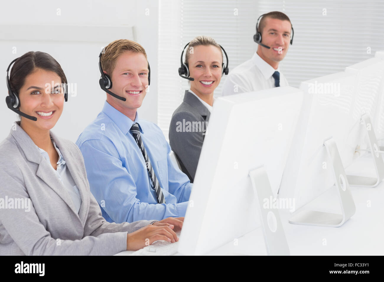 Office team wearing headsets typing hi-res stock photography and images - Alamy