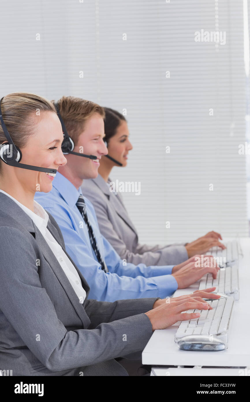 Business team working on computers and wearing headsets Stock Photo - Alamy
