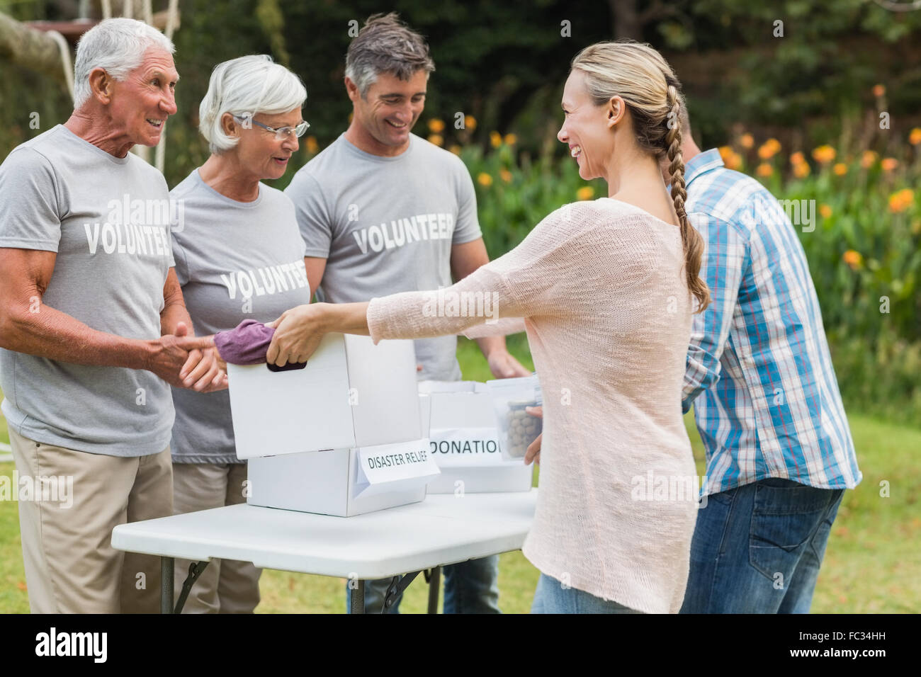 Happy volunteer family separating donations stuffs Stock Photo - Alamy