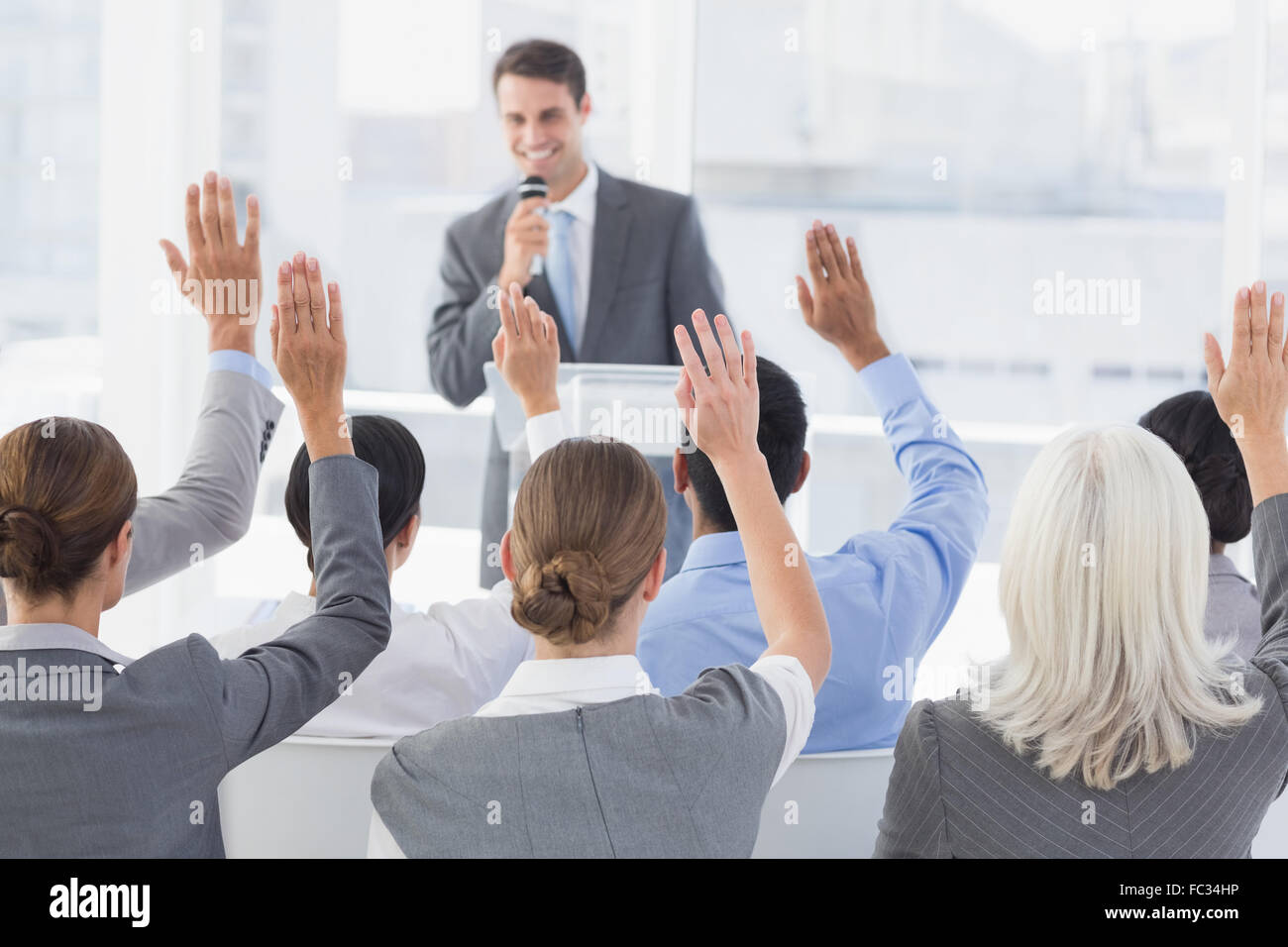 Business people raising their arms during meeting Stock Photo - Alamy