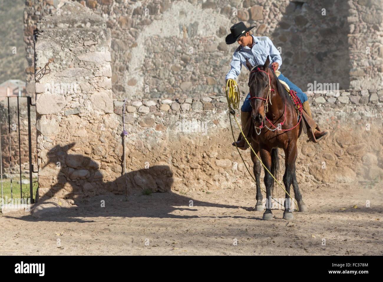 A Mexican charro or cowboy practices roping skills before a Charreada ...