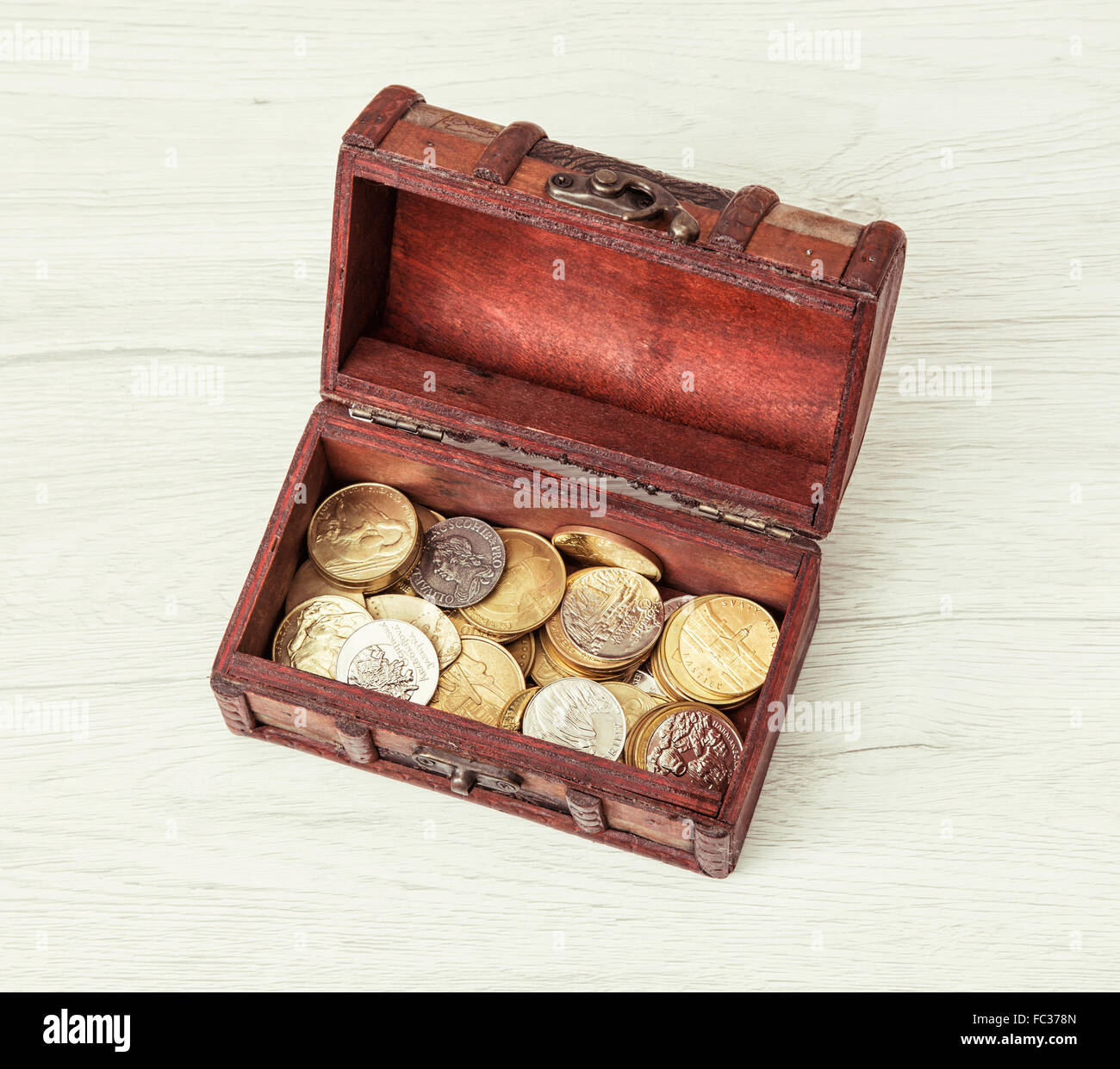 Wooden money chest filled with coins. Wealth theme Stock Photo - Alamy