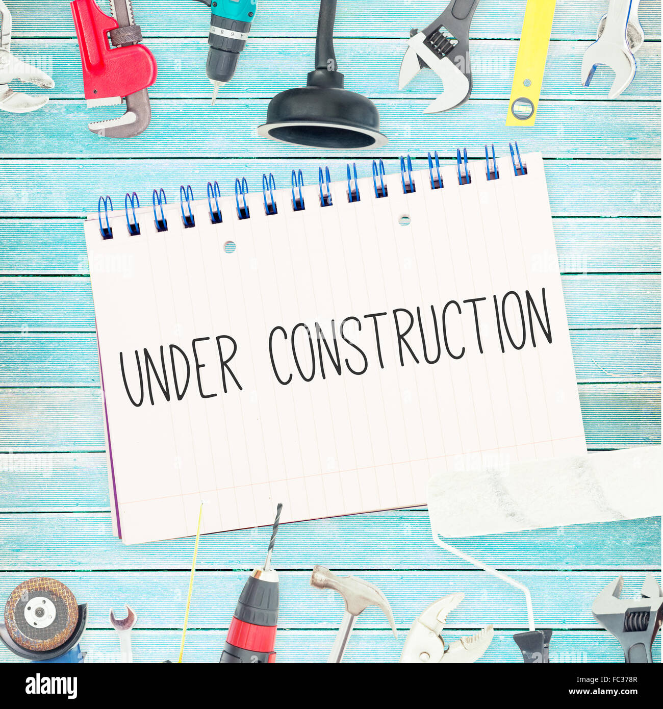 Under construction against tools and notepad on wooden background Stock ...