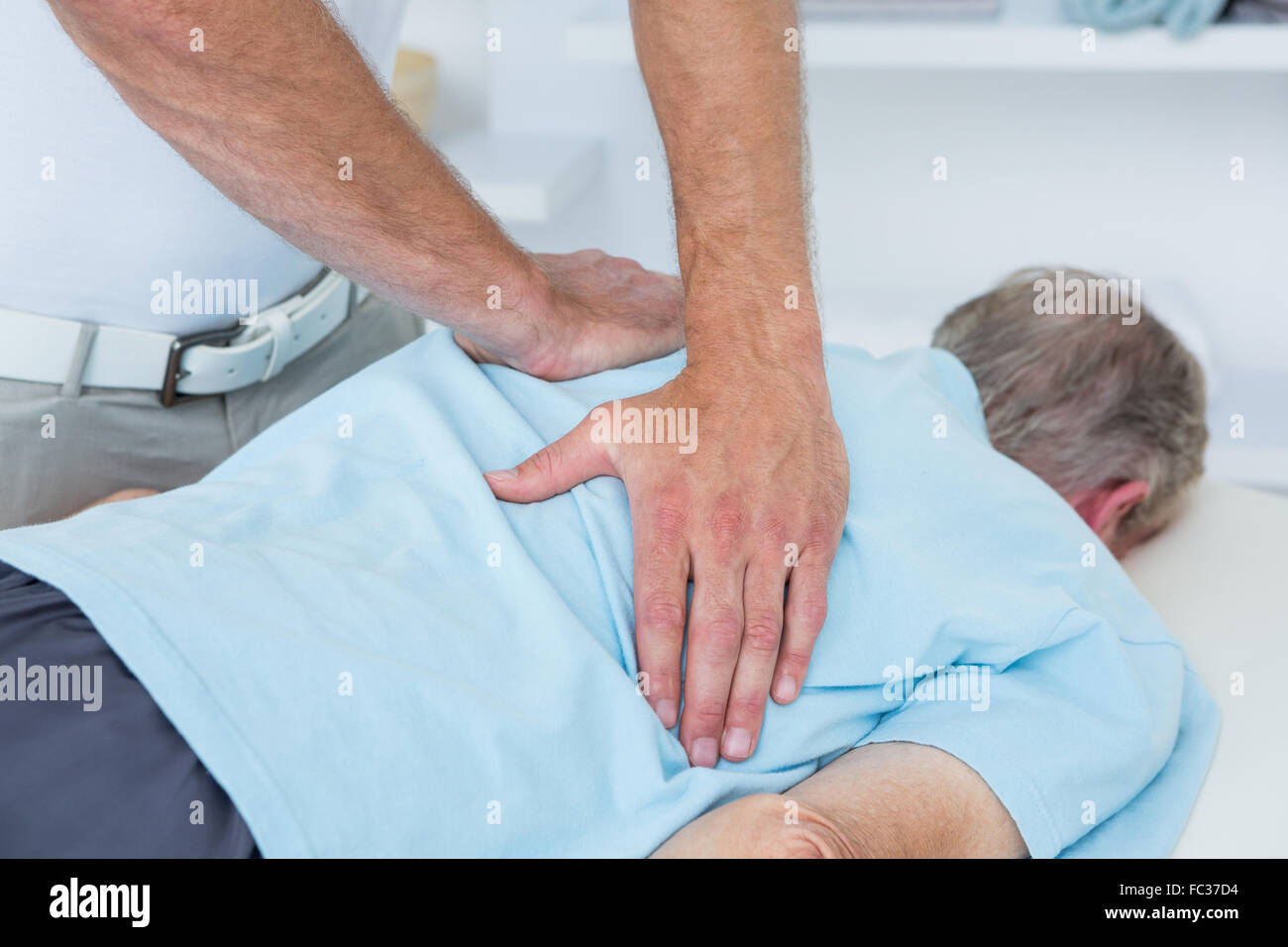 Physiotherapist doing back massage to his patient Stock Photo - Alamy