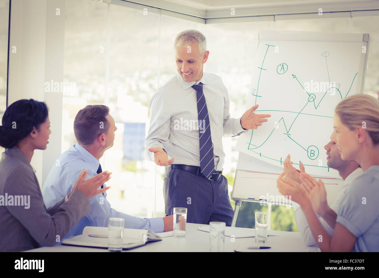 Businessman explaining the graph on the whiteboard Stock Photo - Alamy
