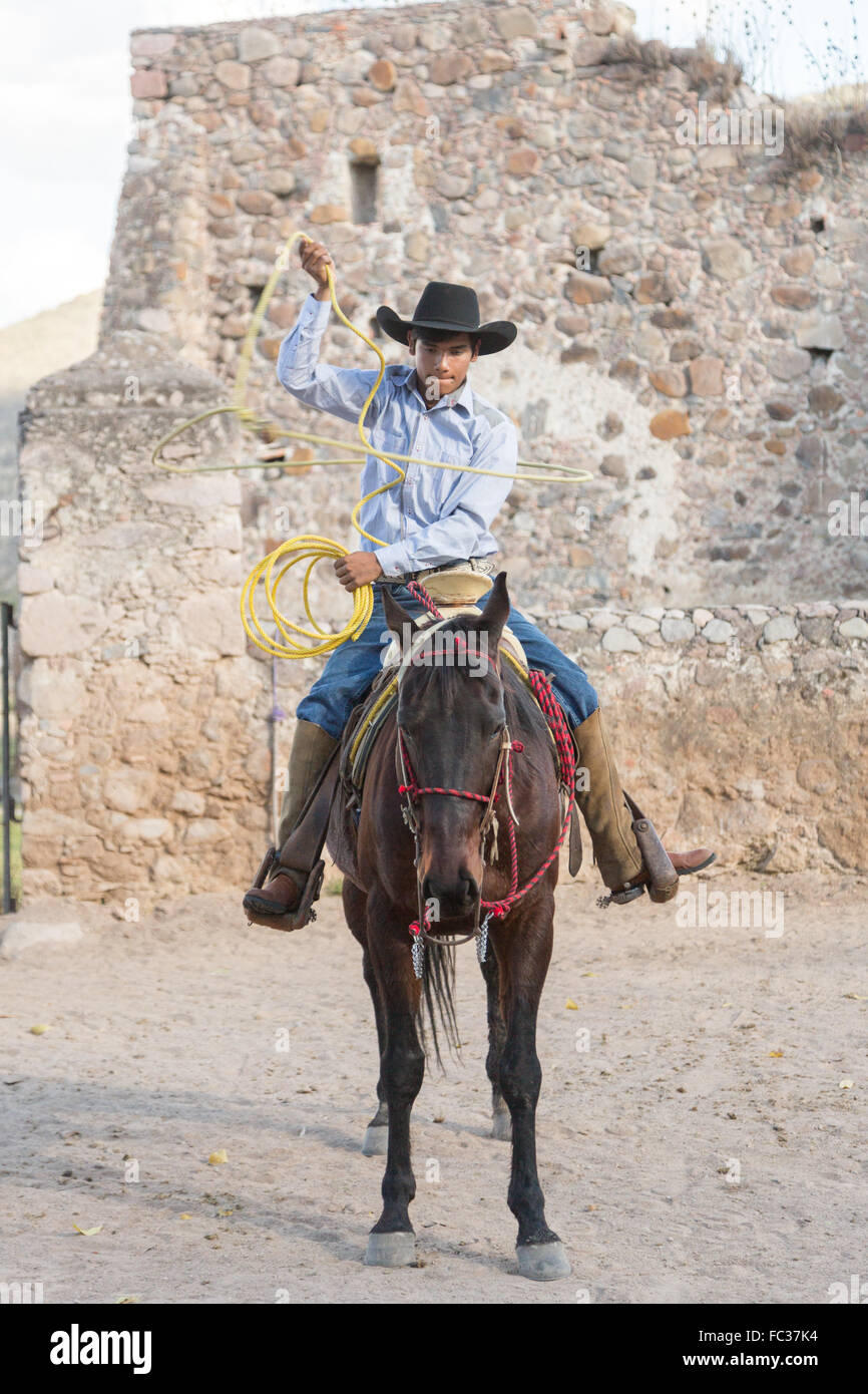 A Mexican charro or cowboy practices roping skills before a Charreada ...