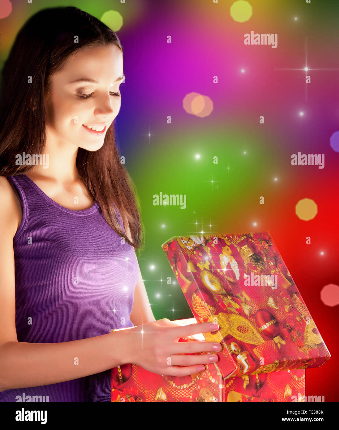 The girl opens the gift Stock Photo - Alamy