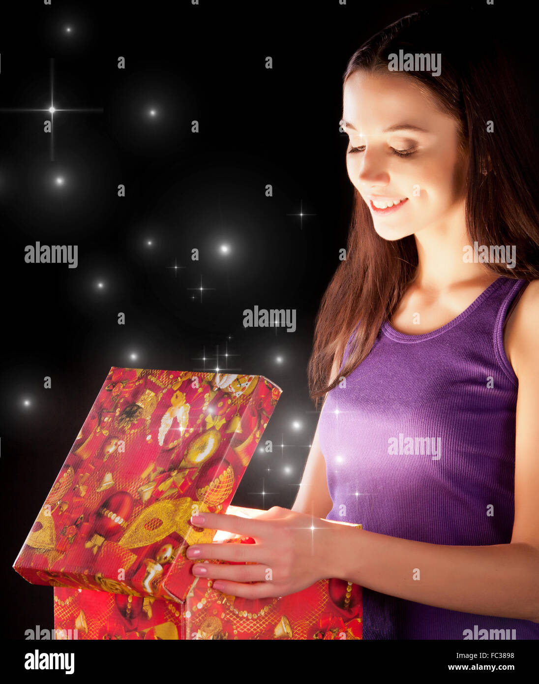 The girl opens the gift Stock Photo - Alamy
