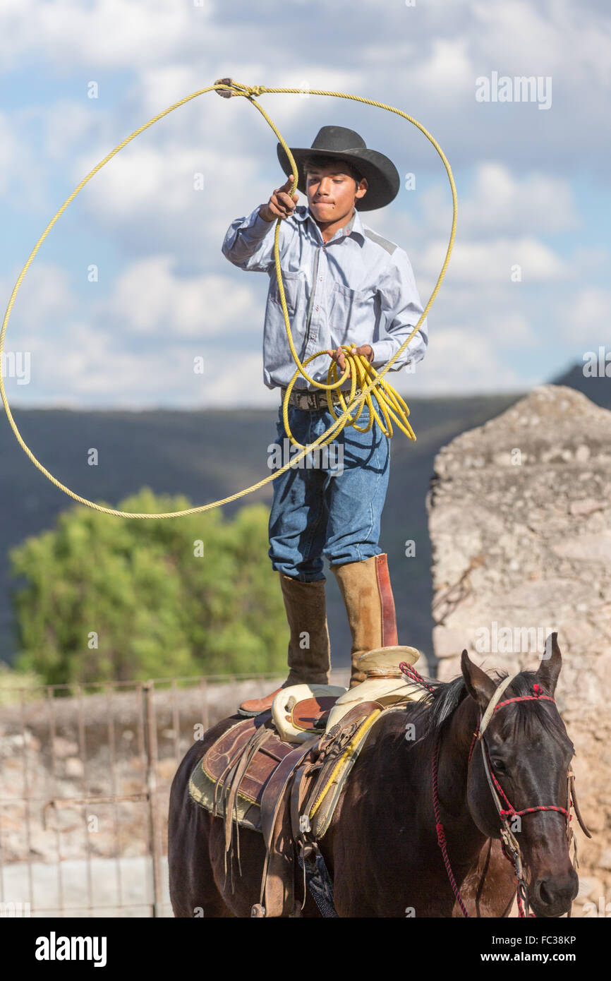 A Mexican charro or cowboy practices roping skills standing on his ...