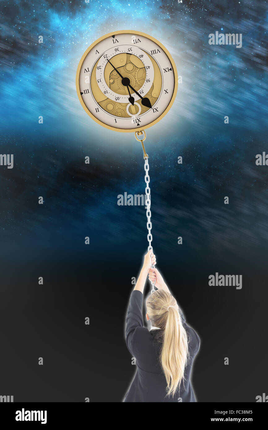 Composite image of businesswoman pulling a chain Stock Photo - Alamy