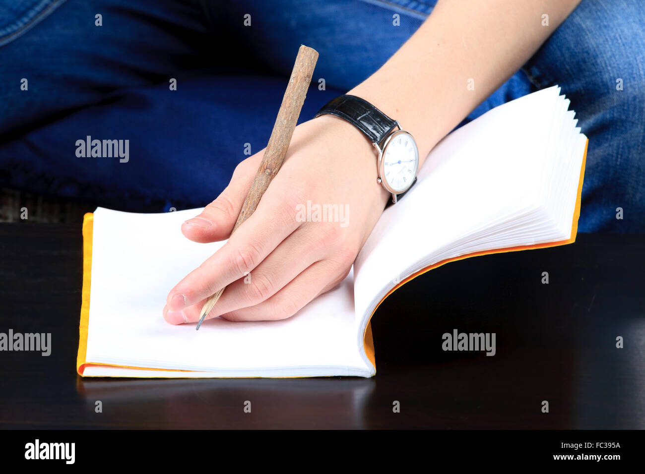 Hand and notebook. Close up Stock Photo - Alamy