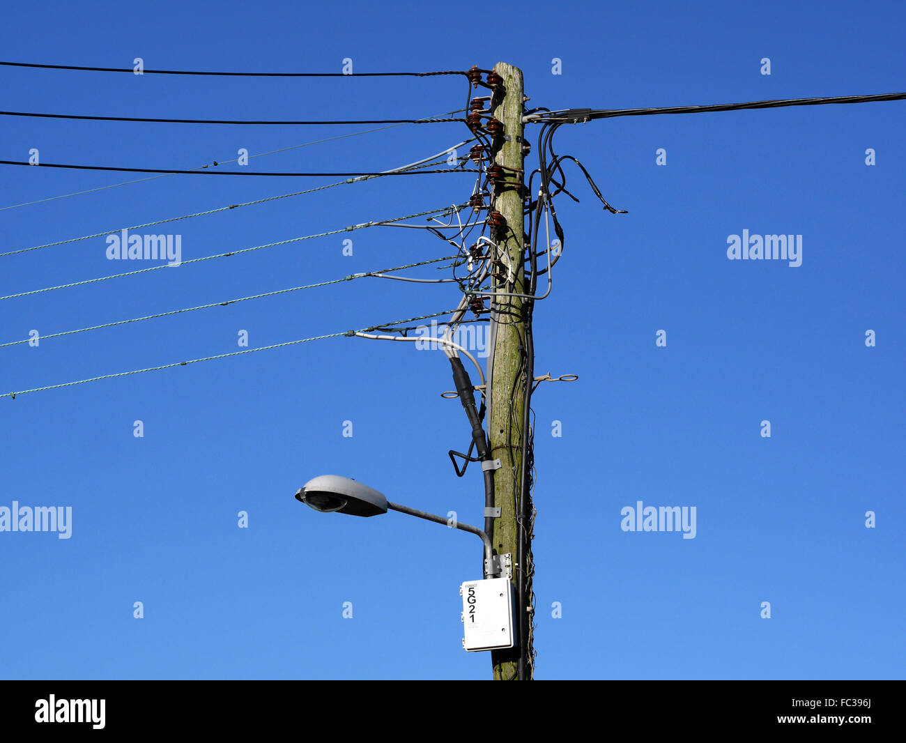 Telegraph post with lots of wires and cables Stock Photo - Alamy