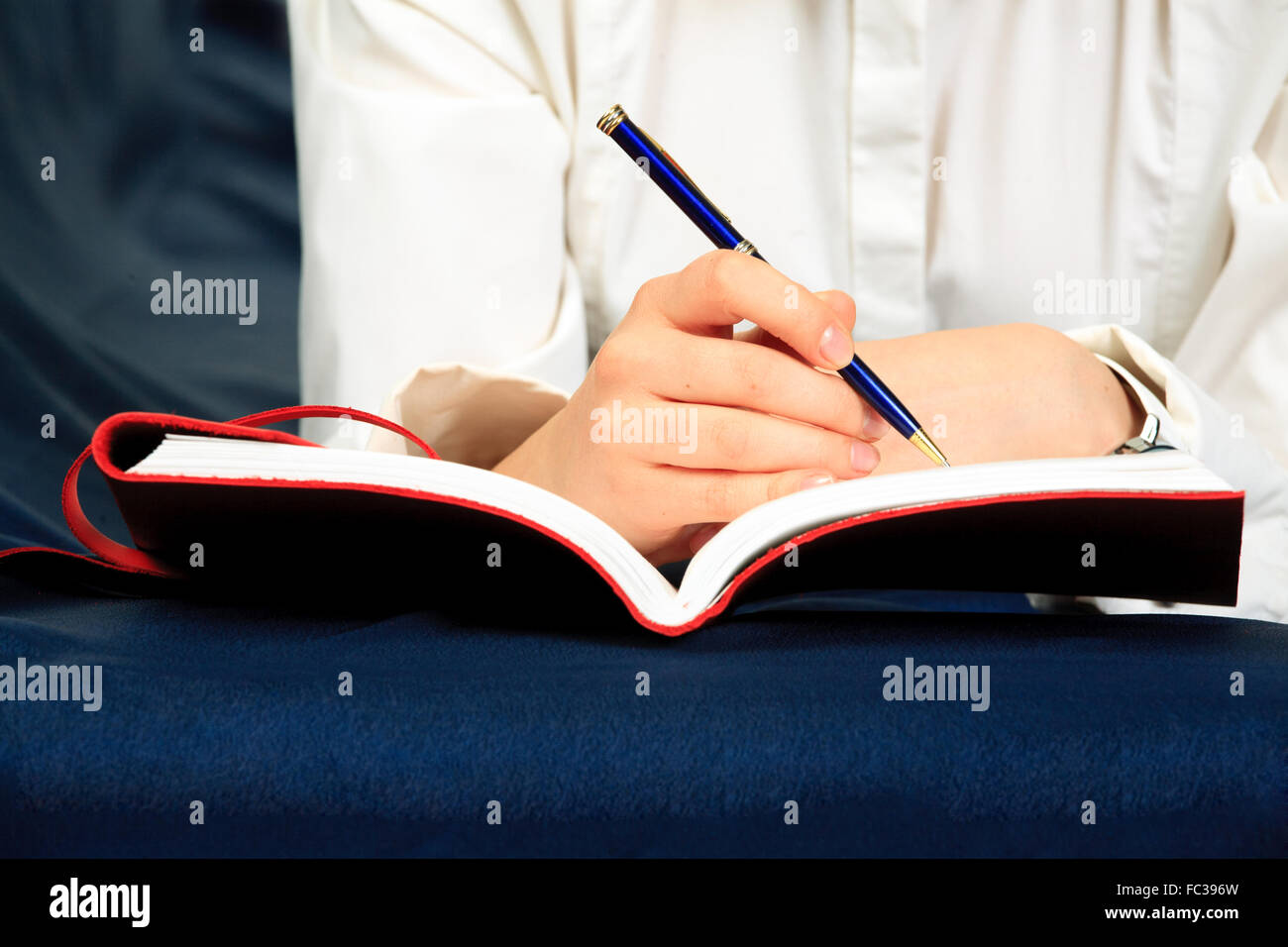 Hand and notebook. Close up Stock Photo - Alamy