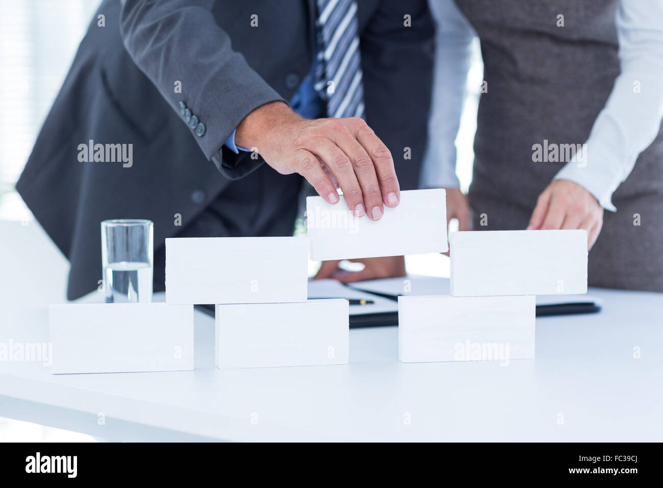 Business people working together and building structure Stock Photo - Alamy