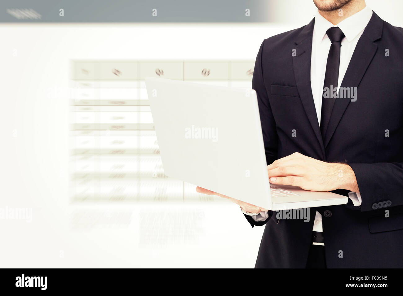 Composite image of mid section of a businessman using laptop Stock ...
