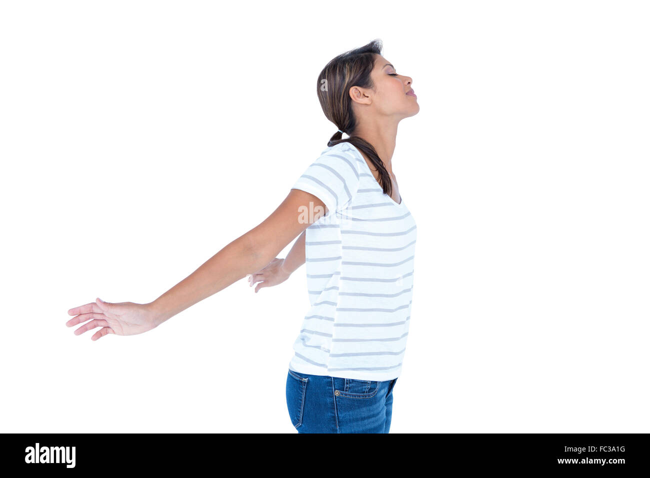 Side view of pretty brunette with arms outstretched Stock Photo - Alamy