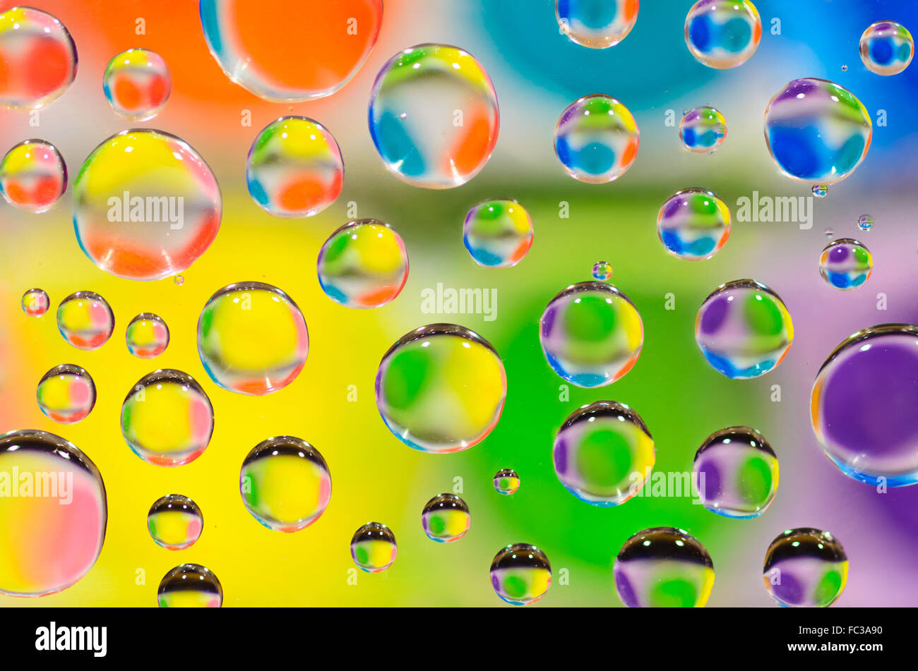 Water droplets on a colorful background Stock Photo - Alamy