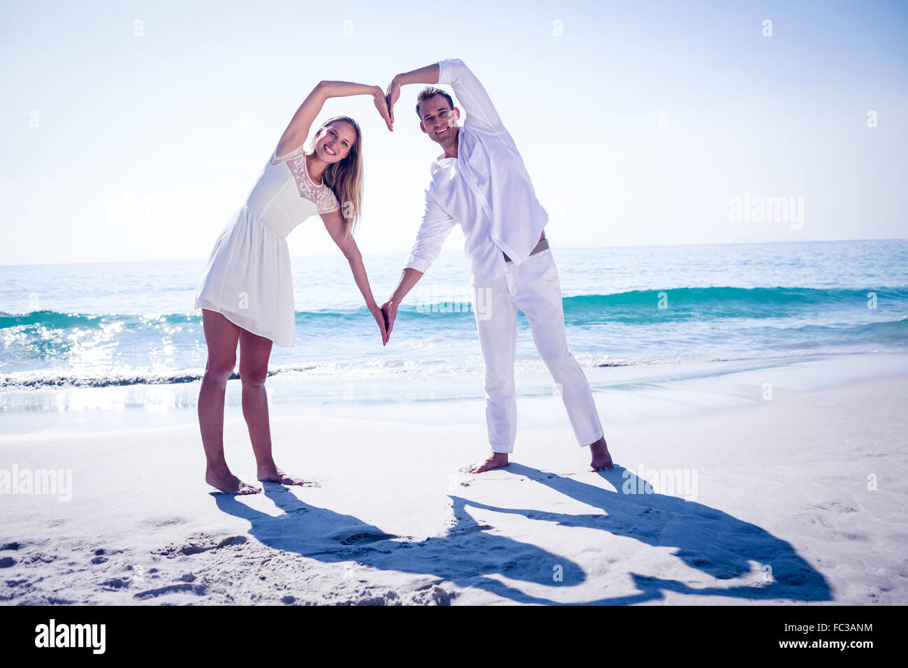 Happy couple forming heart shape with their hands Stock Photo - Alamy