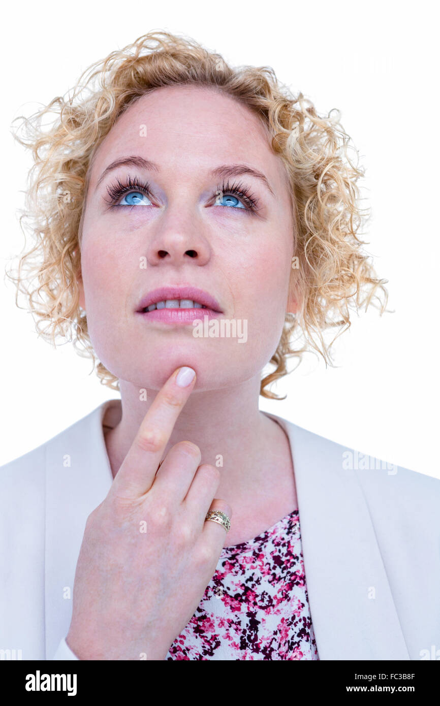 Thoughtful blonde woman looking up with finger on chin Stock Photo - Alamy