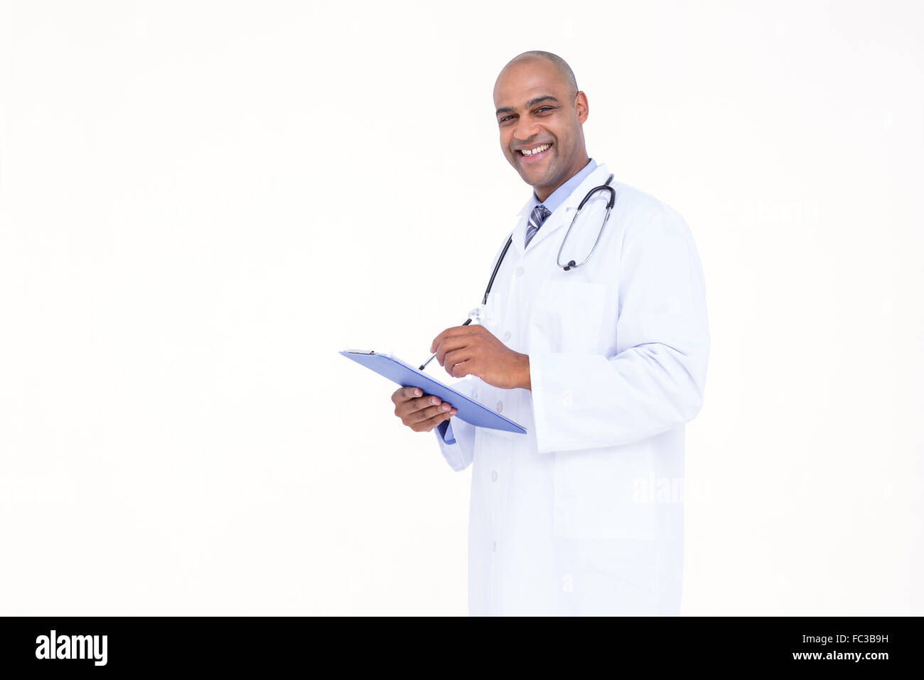 Confident doctor in white tunic writing notes Stock Photo - Alamy