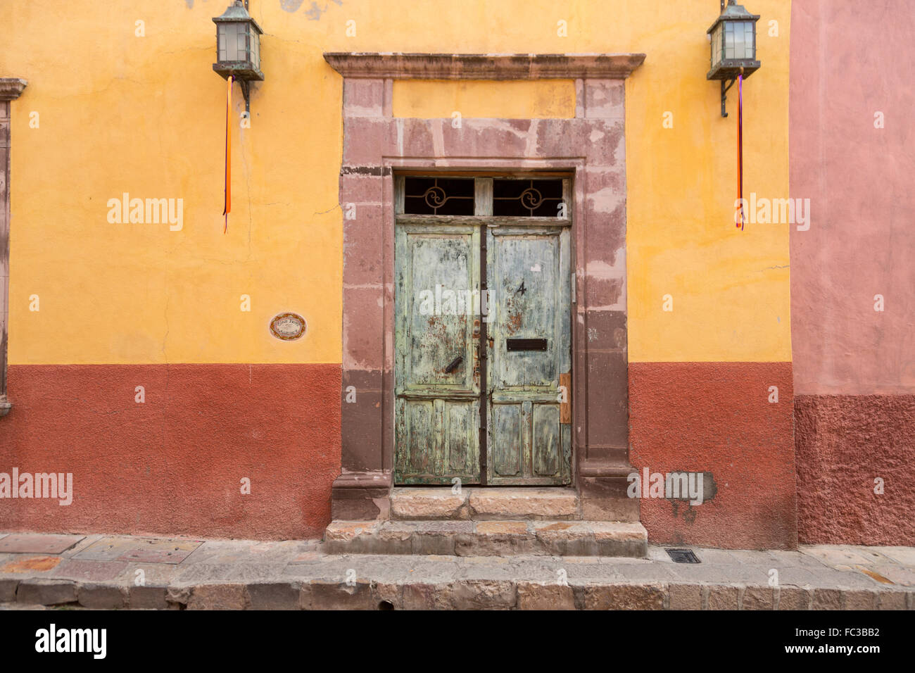 A traditional hacienda style painted wooden door on a historic home in ...