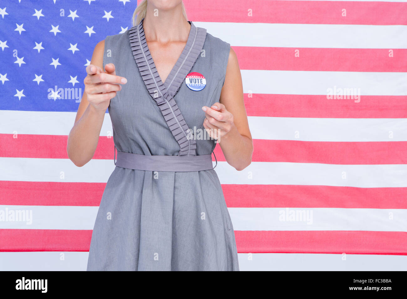 Blonde woman gesturing in front of american flag with badge Stock Photo ...