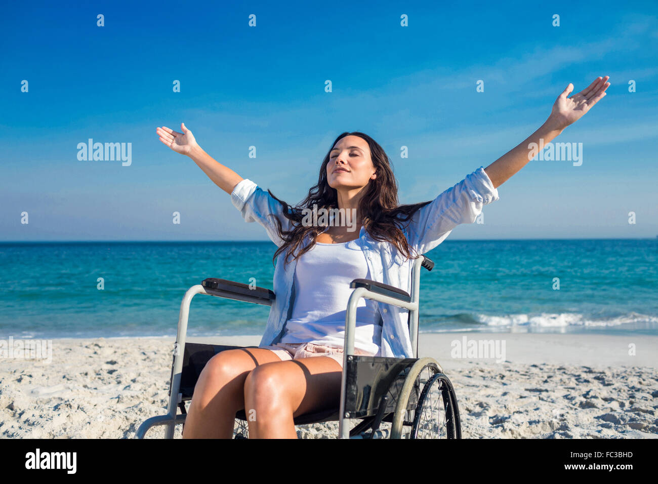 Disabled woman with arms outstretched at the beach Stock Photo - Alamy
