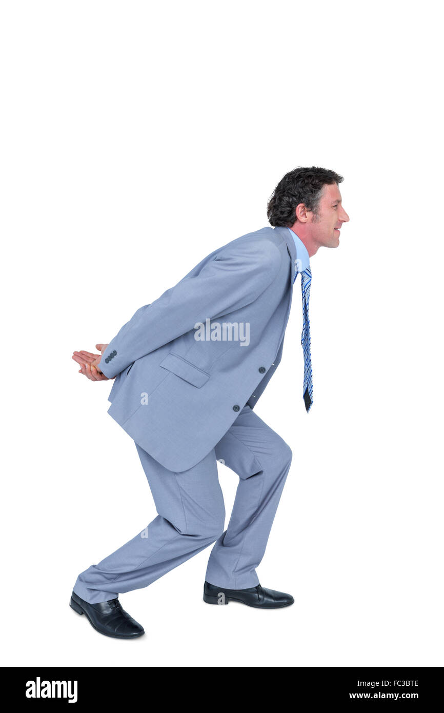 Businessman carrying something with his back and hands Stock Photo - Alamy