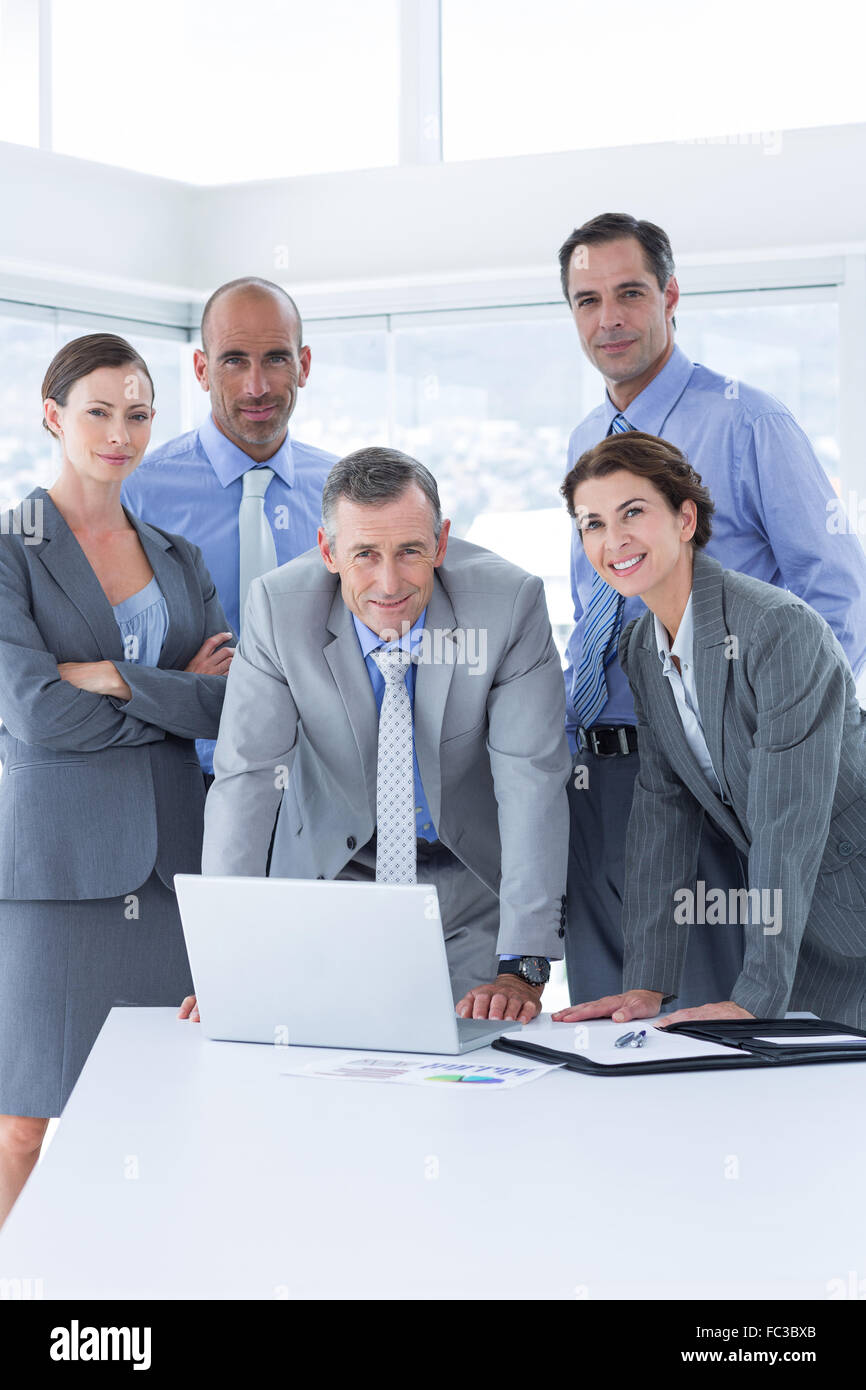 Business team working happily together on laptop Stock Photo - Alamy