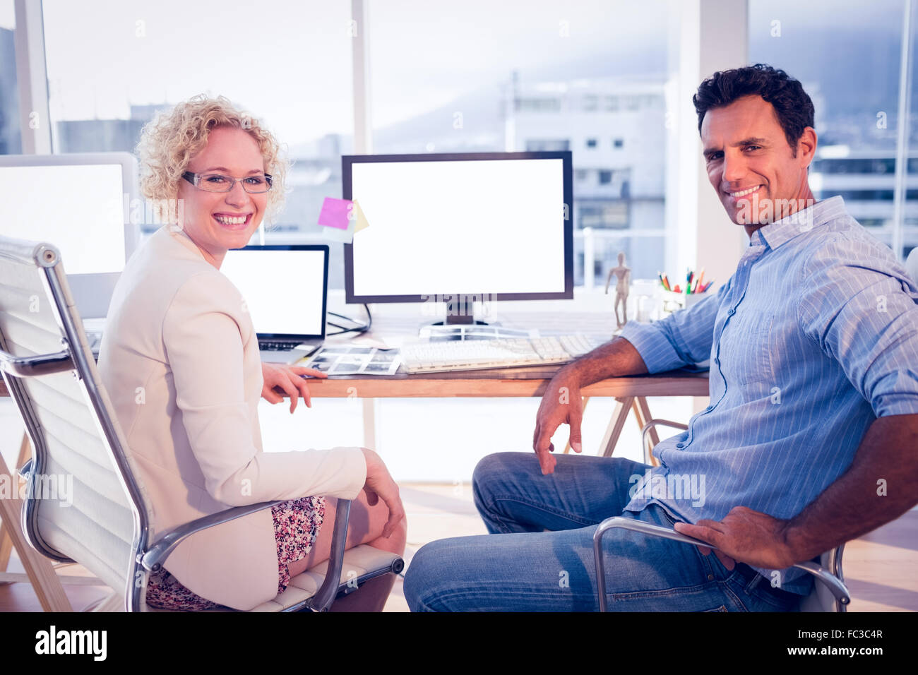 Happy business colleagues smiling at the camera Stock Photo - Alamy